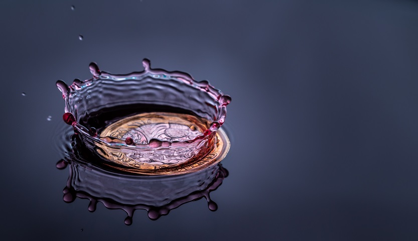 impact of a water drop on a euro coin - BondGuide